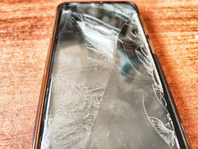 Screen Damage on Smartphone Lying on Wooden Surface with Cracks and ...