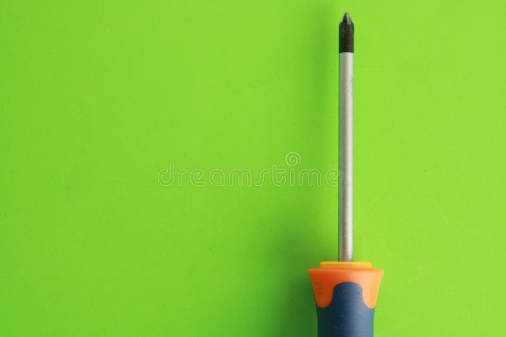 Screwdriver on a Green Surface Stock Photo - Image of engineer, drill ...