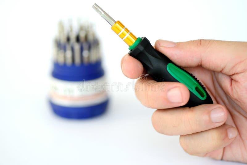 Screwdriver in hand stock photo. Image of repairing, service - 58666092