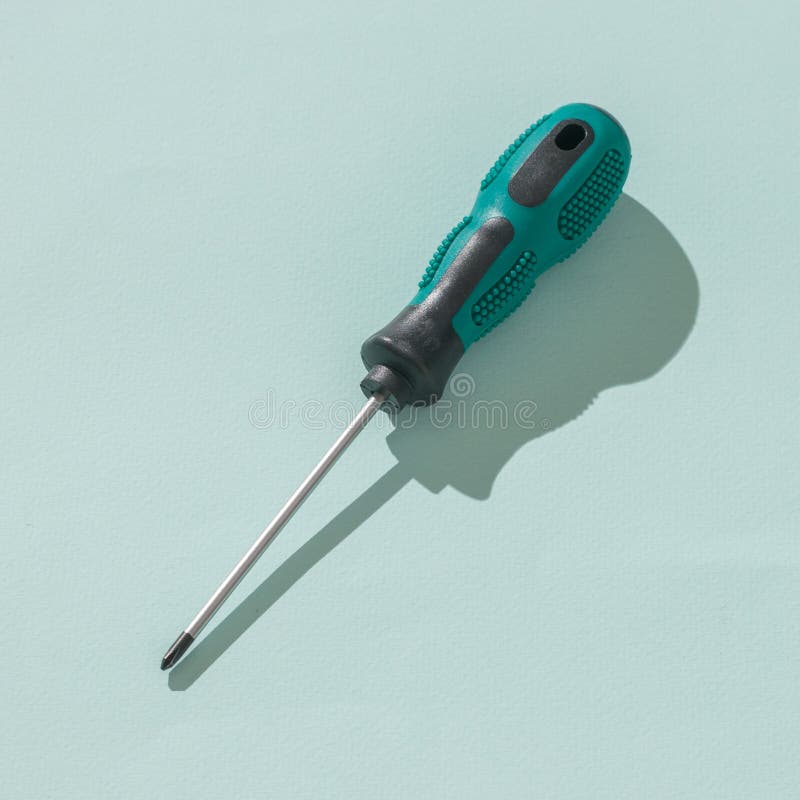 A Screwdriver in Hard Light on a Blue Background Stock Photo - Image of ...