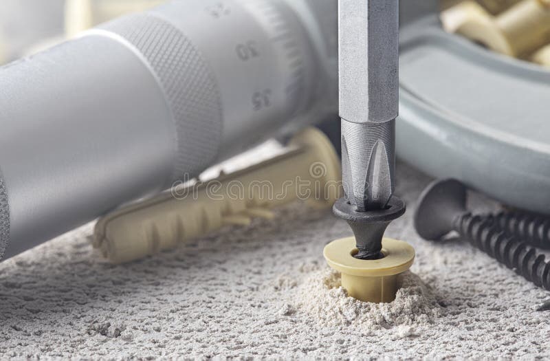 Screwdriver and Dowel in a Concrete Wall Background Stock Photo - Image ...