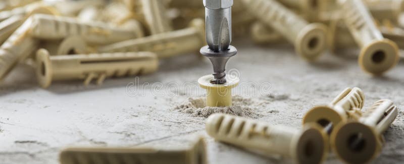 Screwdriver and Dowel in a Concrete Wall Background Stock Image - Image ...