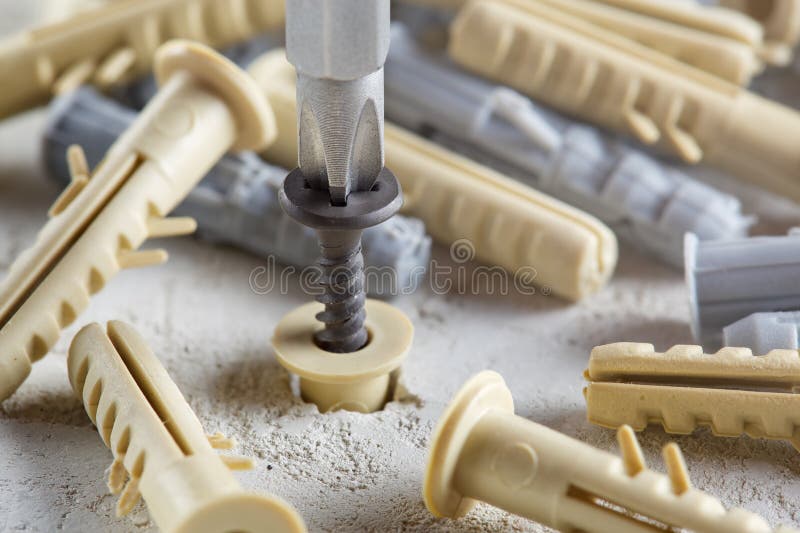 Screwdriver and Dowel in a Concrete Wall Background Stock Photo - Image ...