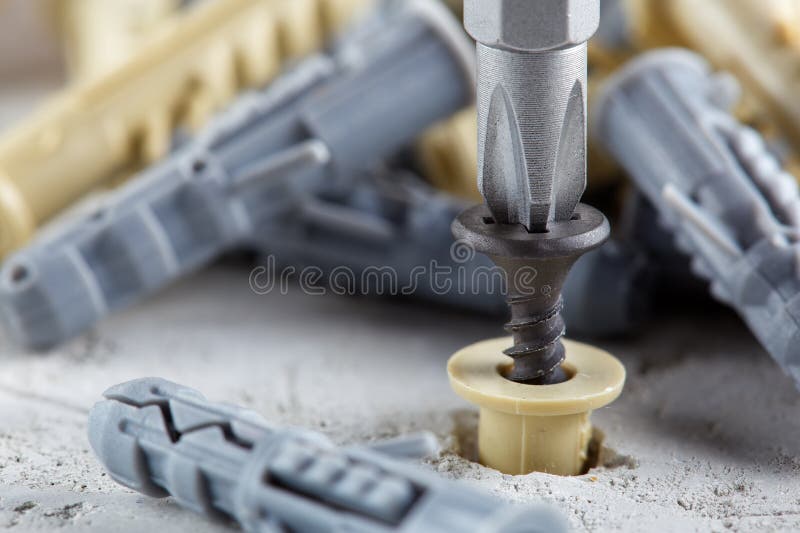 Screwdriver and Dowel in a Concrete Wall Background Stock Image - Image ...