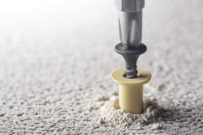 Screwdriver and Dowel in a Concrete Wall Background Stock Photo - Image ...