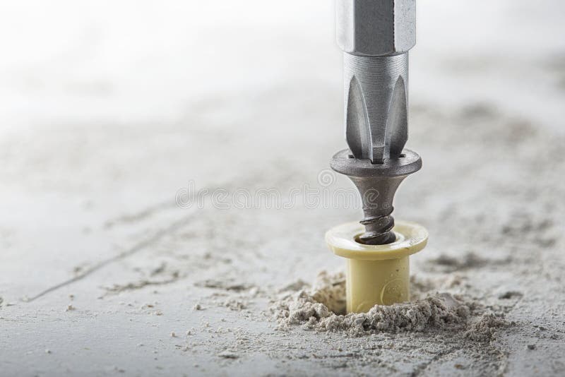 Screwdriver and Dowel in a Concrete Wall Background Stock Photo - Image ...