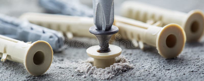 Screwdriver and Dowel in a Concrete Wall Background Stock Photo - Image ...