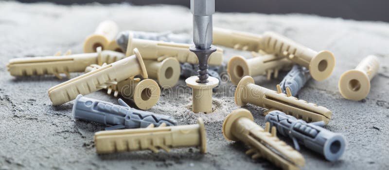 Screwdriver and Dowel in a Concrete Wall Background Stock Photo - Image ...
