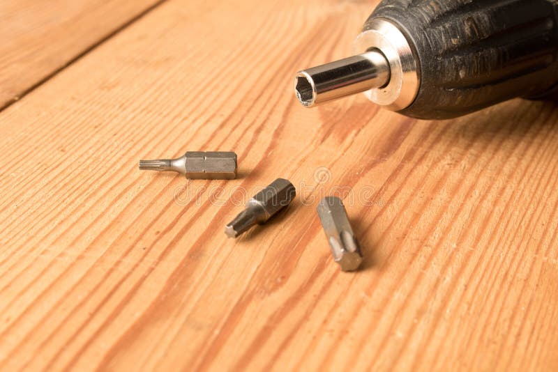 Screwdriver and a Set of Bits on a Wooden Table. the Concept of Stock ...