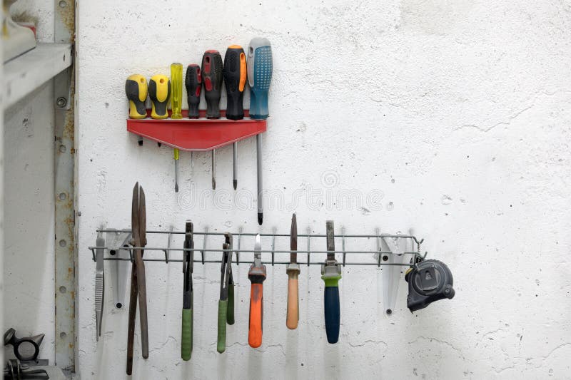 Screwdrivers and Other Tools Hanging on a Wall in a Workshop Stock ...