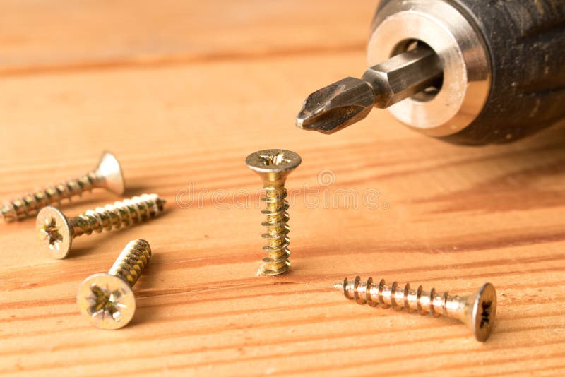Screwdrivers and Screws on a Wooden Table. the Concept of Work Stock ...