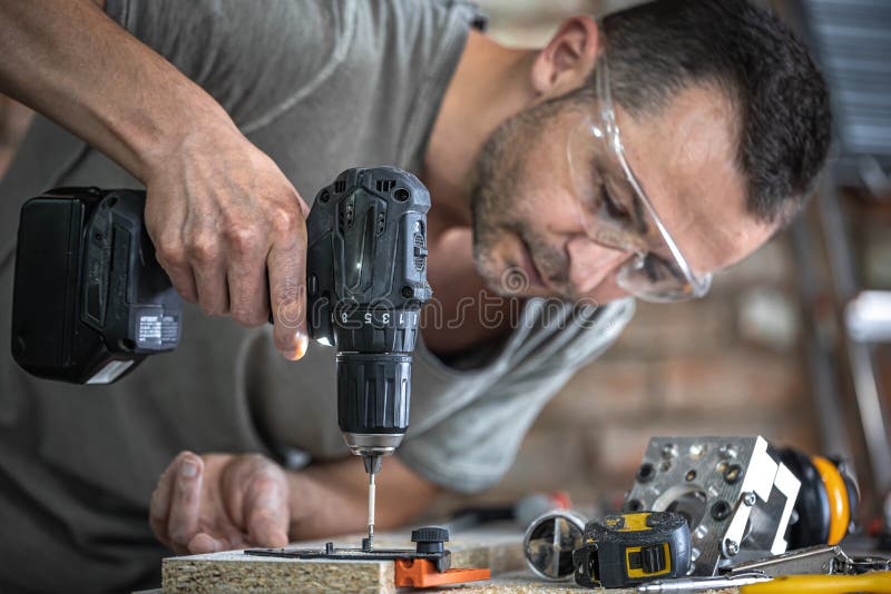 A Professional Carpenter Uses Wood Screws, Screws Stock Photo - Image ...