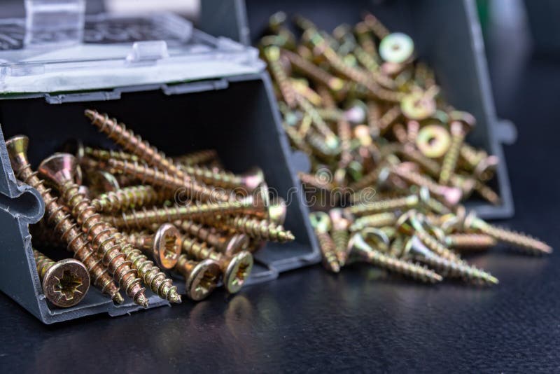 Screws in a Box and a Screwdriver on a Workshop Table. Accessories for ...