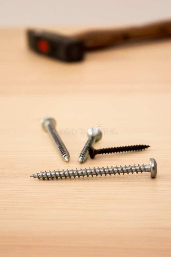 Screws and Hammer on a Table Stock Photo - Image of gouge, metal: 36154044