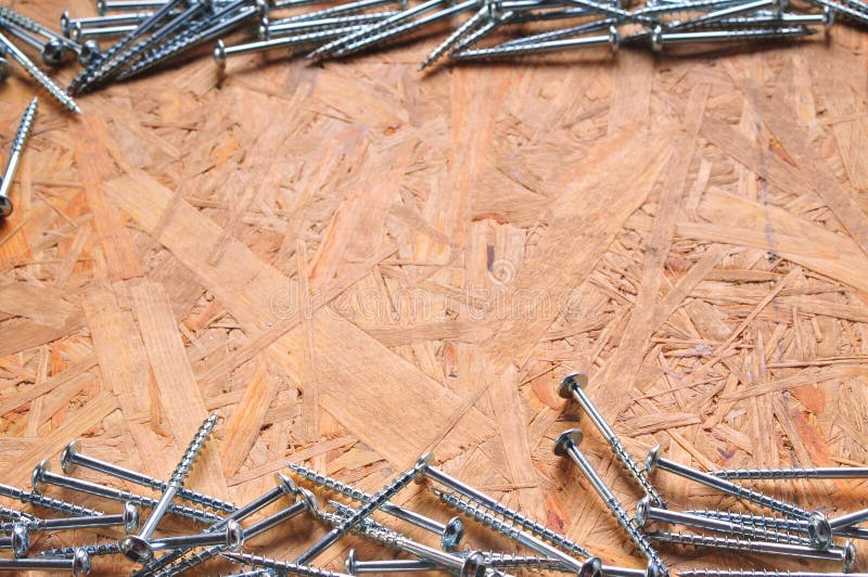 Screws on the wooden table stock image. Image of steel - 100957337