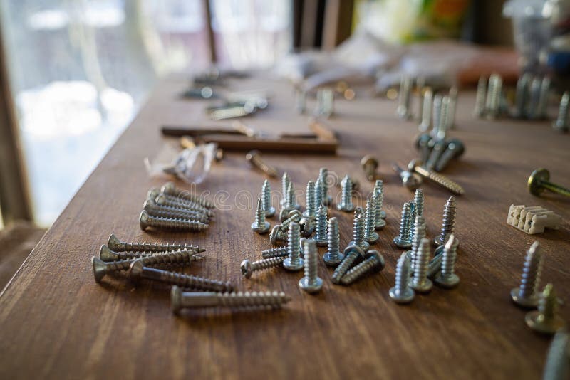 Screws and Self-tapping Screws of Various Lengths on a Wooden Table ...