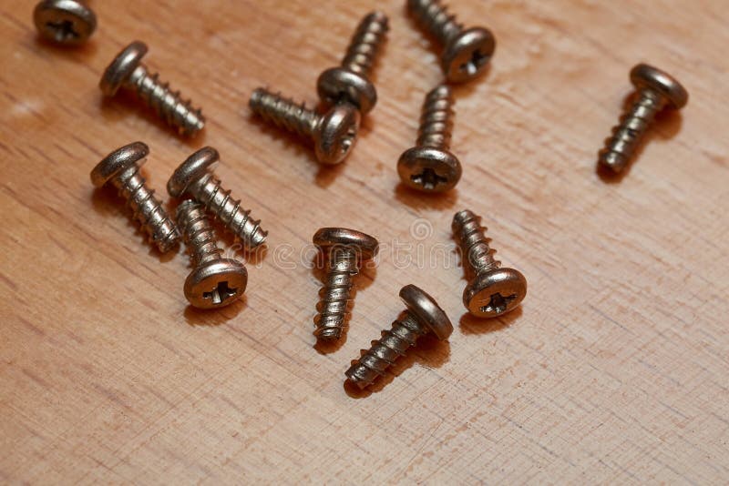 Screws on a table stock image. Image of supply, metallic - 203512347