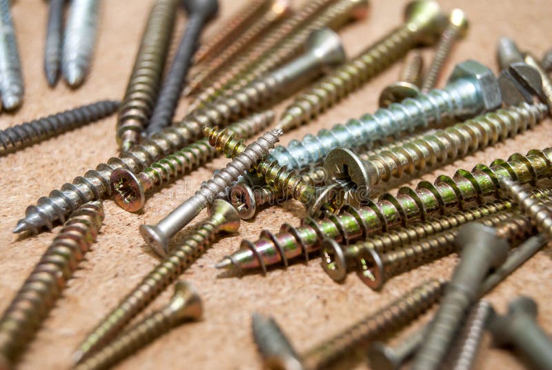 Screws on a wooden table stock photo. Image of bolt, head - 54622126