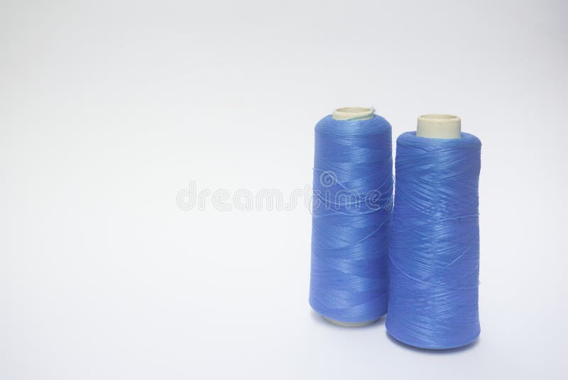 A Scroll Blue Color Sewing Thread with White Background for Sewing ...