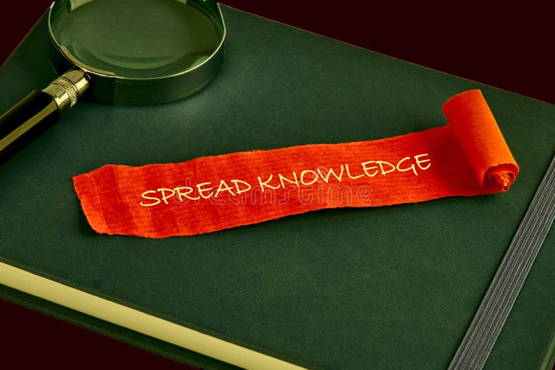 A Scroll with the Words Spread Knowledge Rests on a Dark Surface, Symbolizing the Importance of ...
