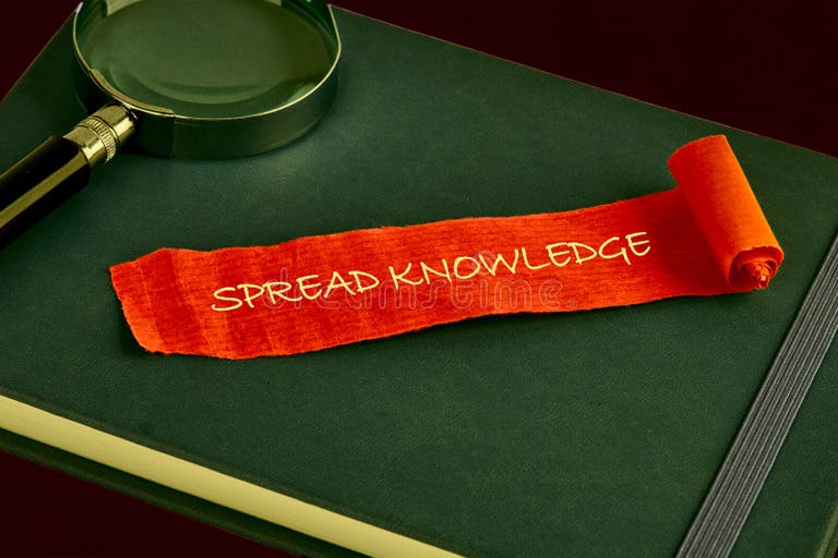 A Scroll with the Words Spread Knowledge Rests on a Dark Surface, Symbolizing the Importance of ...