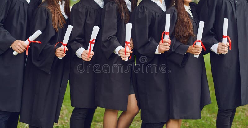 Scrolls of Diplomas in the Hands of a Group of Graduates. Stock Photo ...