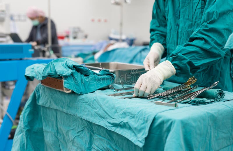 Scrub Nurse Preparing Medical Instruments for Operation Stock Photo ...