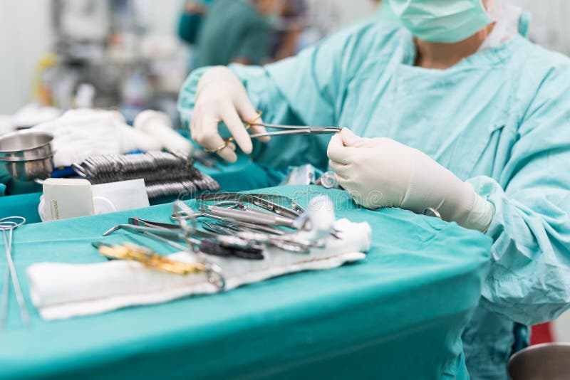 Scrub Nurse Preparing Medical Instruments for Operation Stock Photo ...