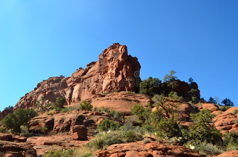 Scrub and Trees at the Base of a Red Rock Stock Image - Image of butte ...
