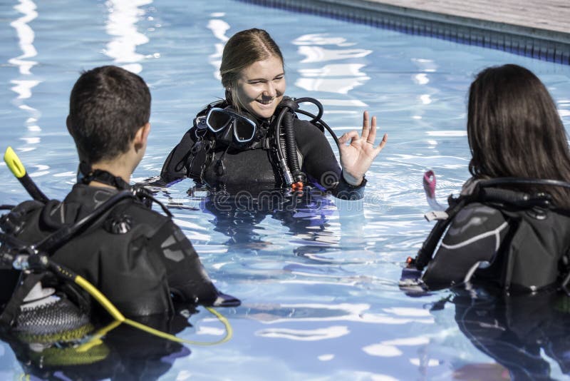 Scuba Dive Training in the Pool with an Instructor Showing the OK Sign ...