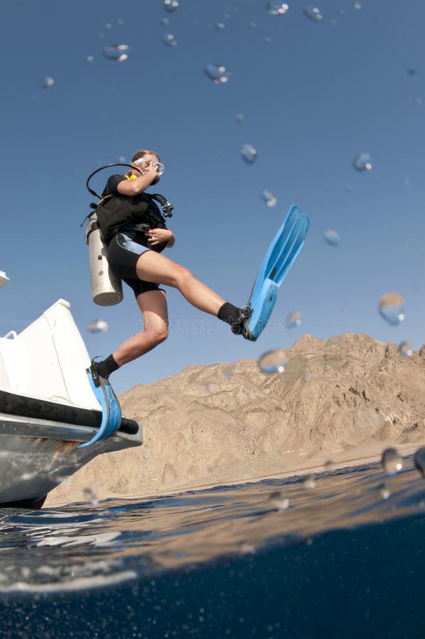 Scuba diver jumps off boat stock image. Image of dive - 24556835