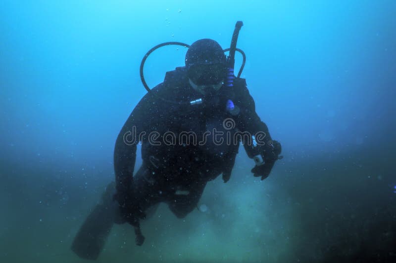 Scuba Diver Swimming on a Blue Water Looking at Camera Stock Photo ...