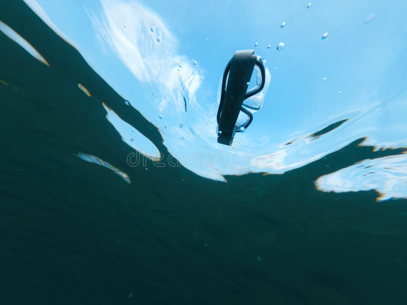 Scuba Diving Mask Floating in Ocean Water, Underwater Shot with Low ...