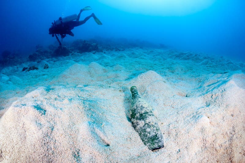 SCUBA Diving Swimming Next To a Discarded Bottle Stock Photo - Image of ...