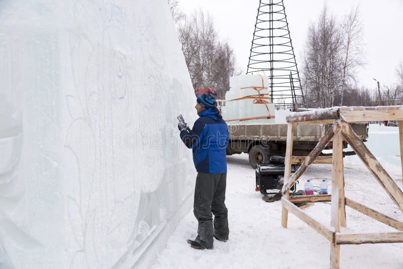Sculptor in a Blue Winter Suit with a Chisel in His Hands at Work Stock ...