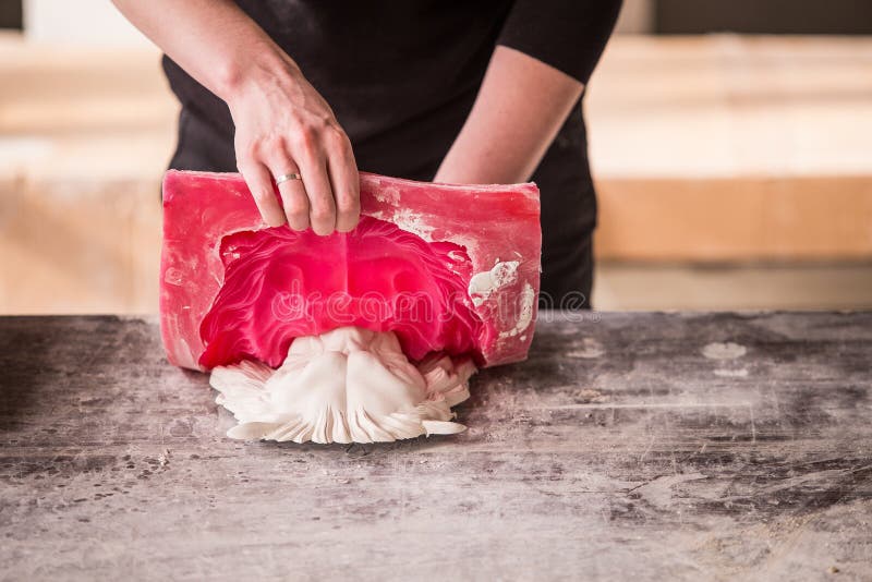The Sculptor Works in a Plaster Workshop. Separates the Silicone Mold ...