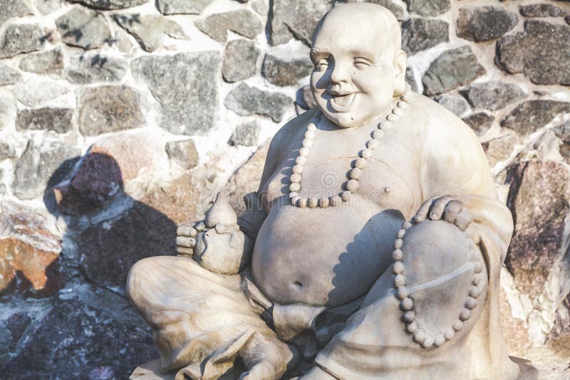 Sculpture Hotei on Background of Stone Wall Stock Image - Image of ...