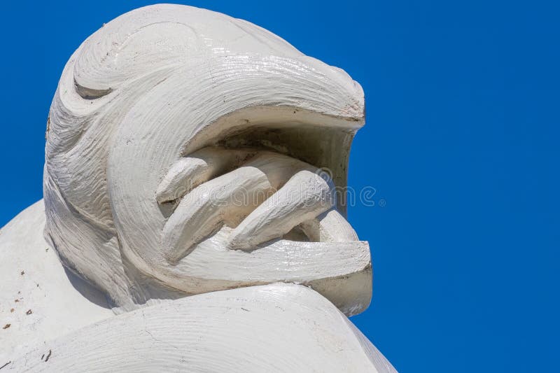 Sculpture of a Human Figure Against a Vivid Blue Sky Background ...