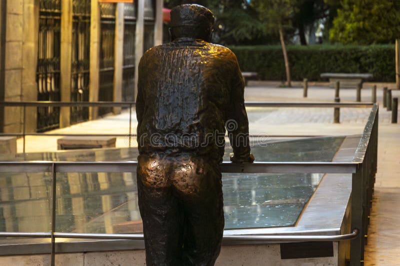 A Sculpture of a Man with a Large Posterior, Leaning on a Railing Stock ...