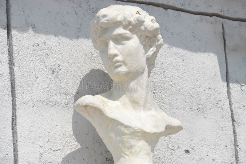 A Sculpture of a Mans Head Displayed Against a White Wall Stock Photo ...