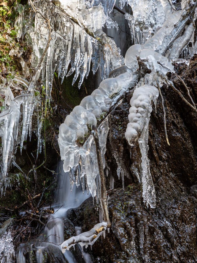 Sculptures of Ice Hanging Over a Waterfall Stock Photo - Image of ...