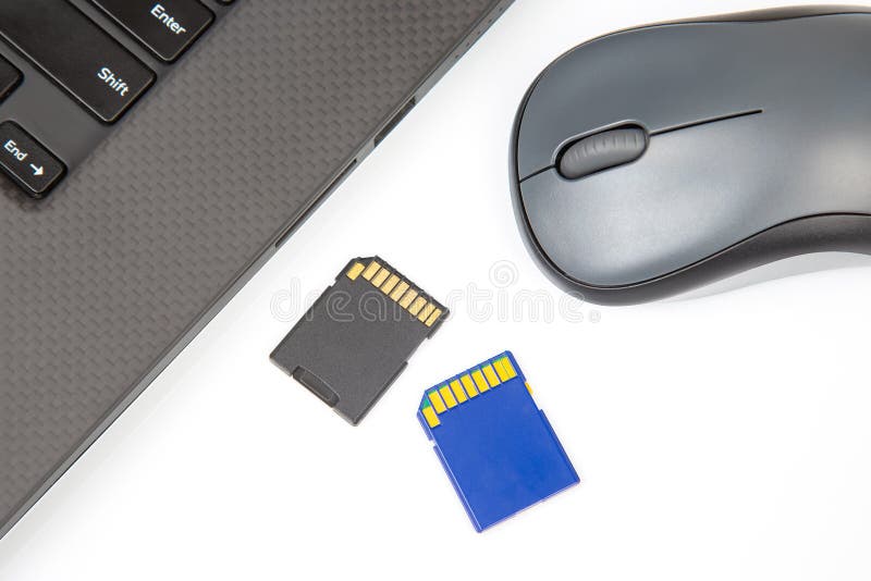 Sd Memory Card for Recording Electronic Data Near a Laptop on a White ...
