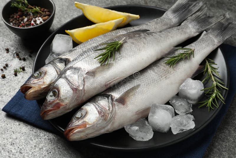 Sea Bass Fish and Ingredients on Grey Table, Closeup Stock Image ...