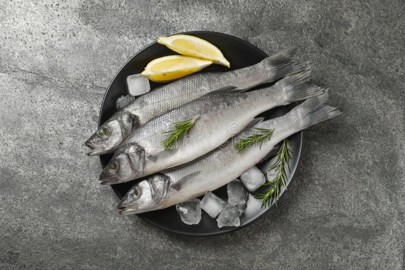 Sea Bass Fish and Ingredients on Grey Table, Top View Stock Image ...