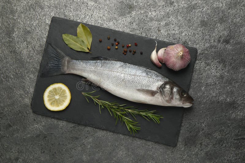 Sea Bass Fish and Ingredients on Grey Table, Top View Stock Image ...