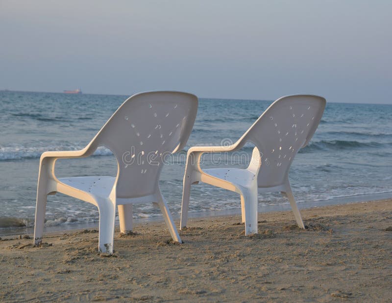 Sea stock image. Image of waves, sunset, chairs, beach - 165049069