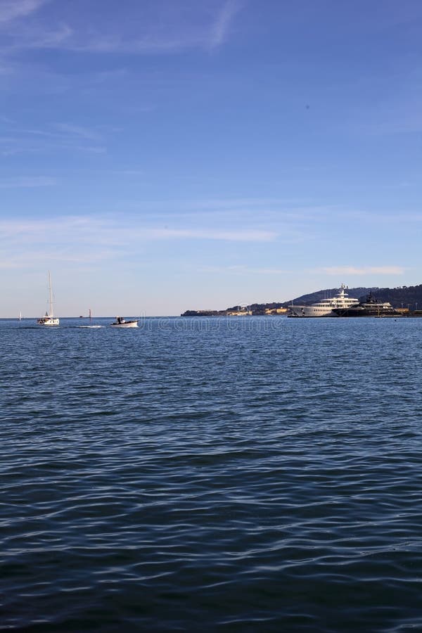 Sea and a Cliff in a Bay Seen from the Distance at Sunset Stock Photo ...