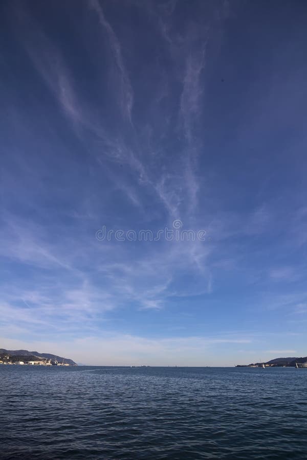 Sea and a Cliff in a Bay Seen from the Distance at Sunset Stock Image ...