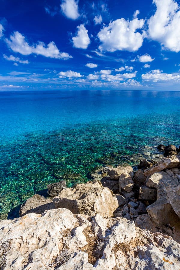 Sea Coast with Clear Turquoise Water and Sharp Stones, Blue Sky with ...