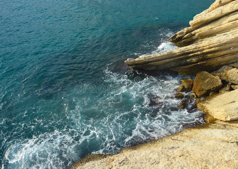 Sea Coast with Sand-colored Rock and Foaming Wave Stock Image - Image ...